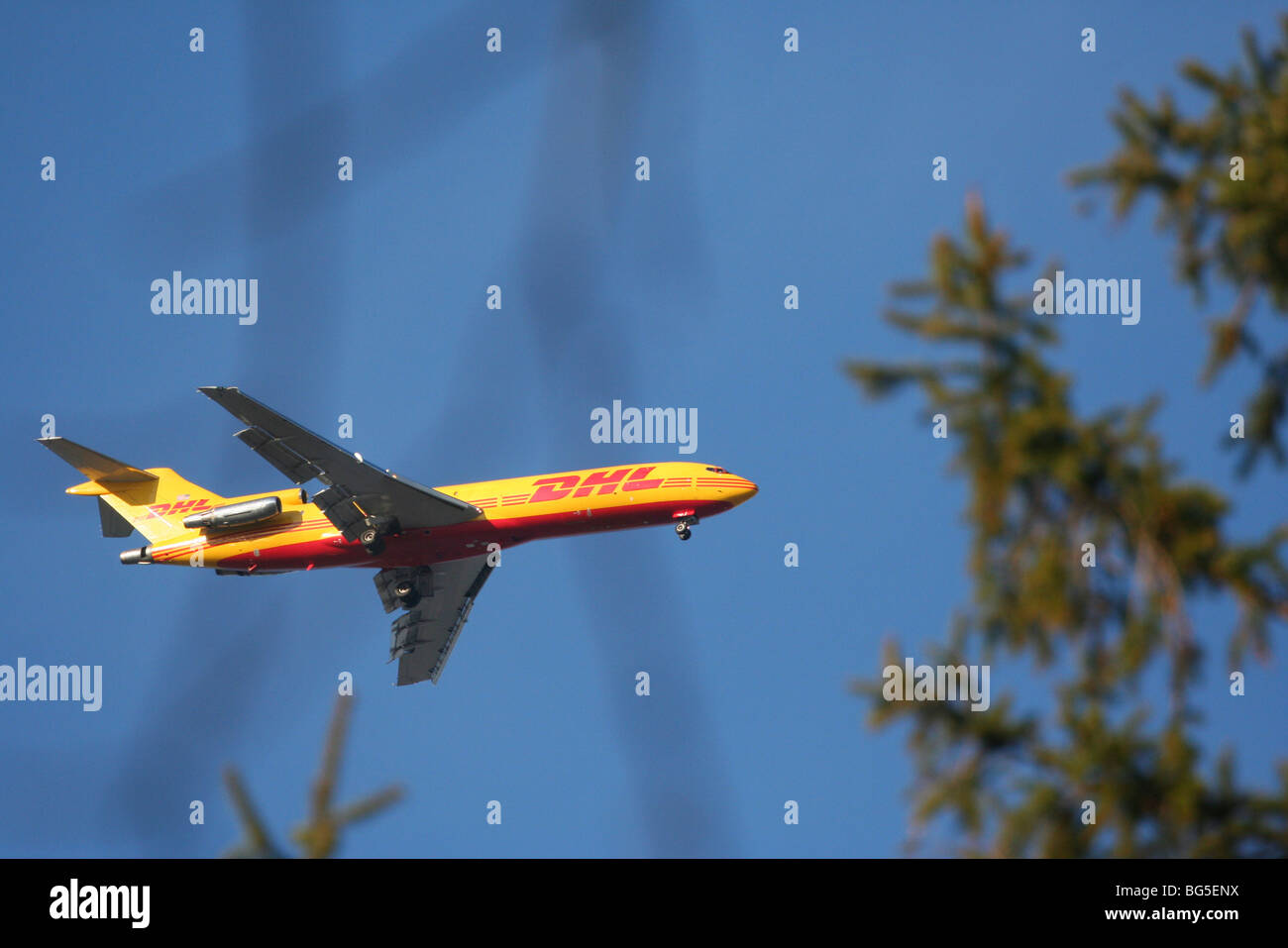 Yellow DHL cargo plane in flight Stock Photo - Alamy