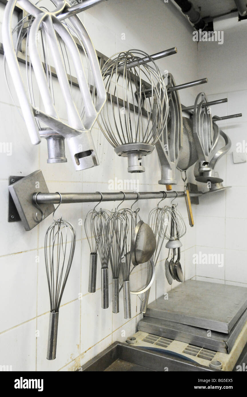 Industrial Bakery. Baker's Tools and equipment hanging on the wall ...