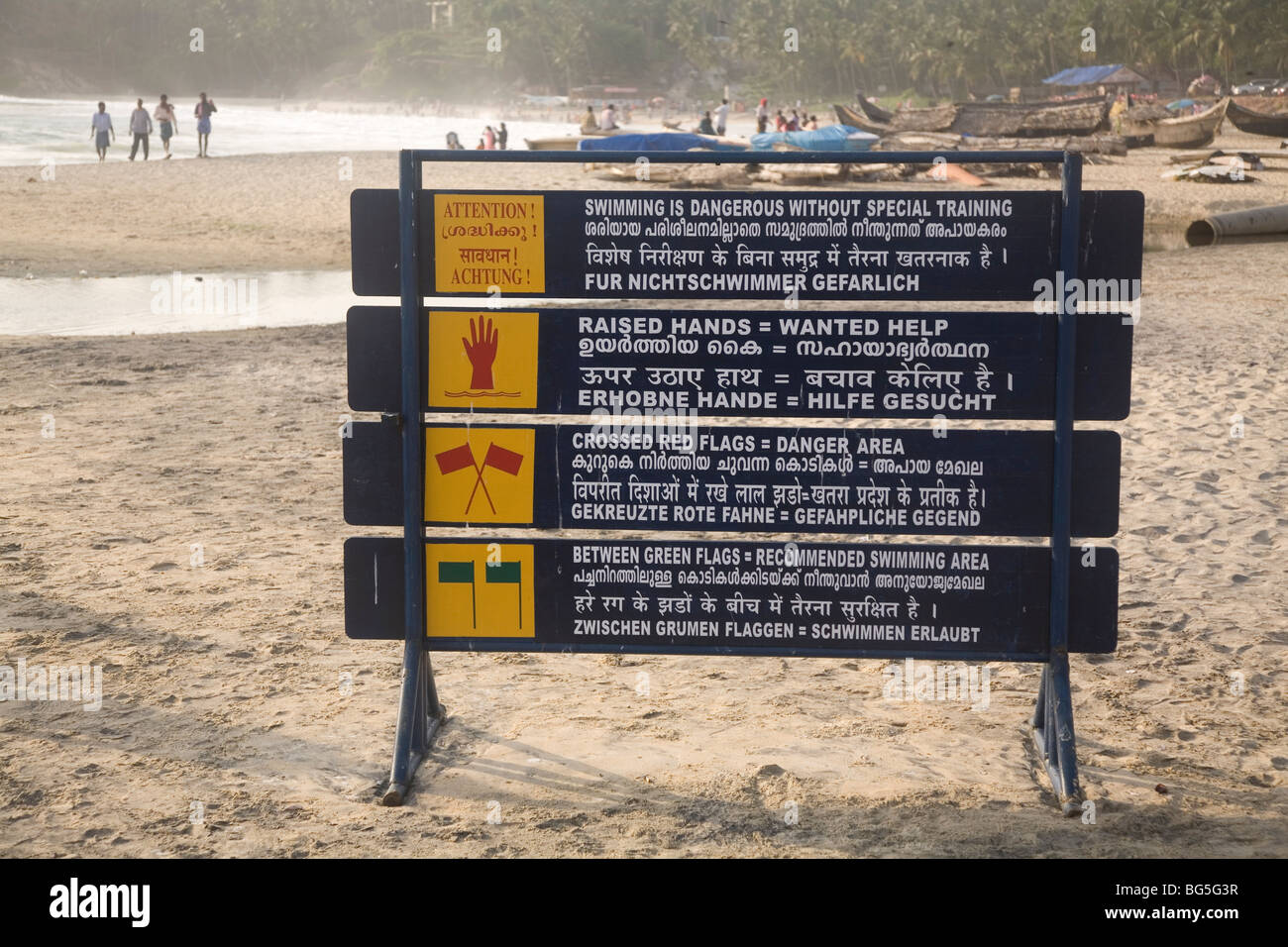 A multilingual sign warns bathers of the dangers posed on Kovalam Beach ...