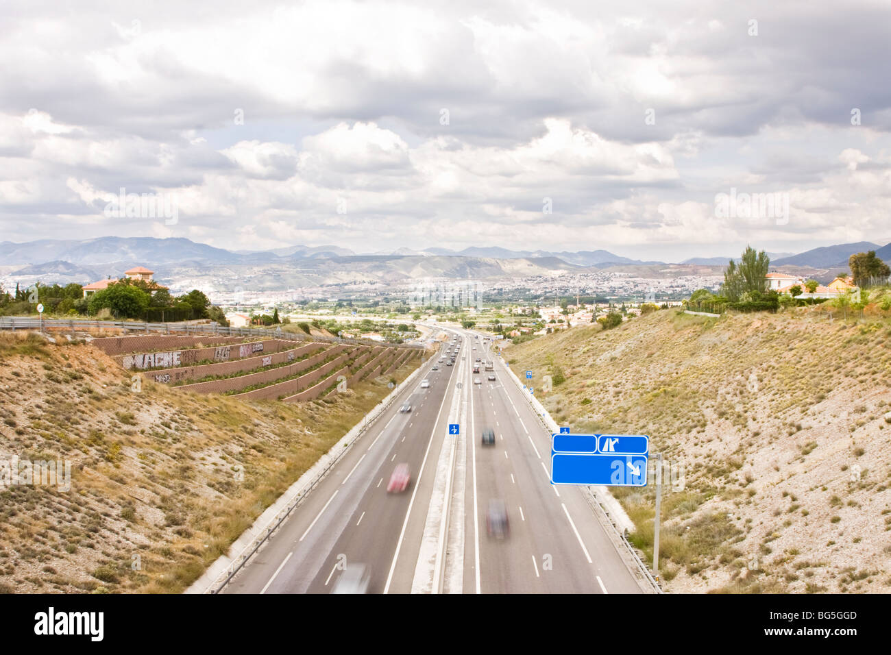 Highway to the city, blank blue sign in one side Stock Photo - Alamy
