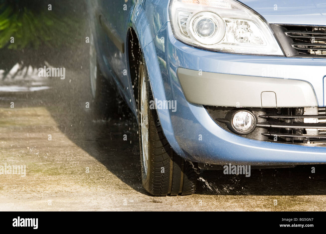 Blue car during washing process Stock Photo - Alamy