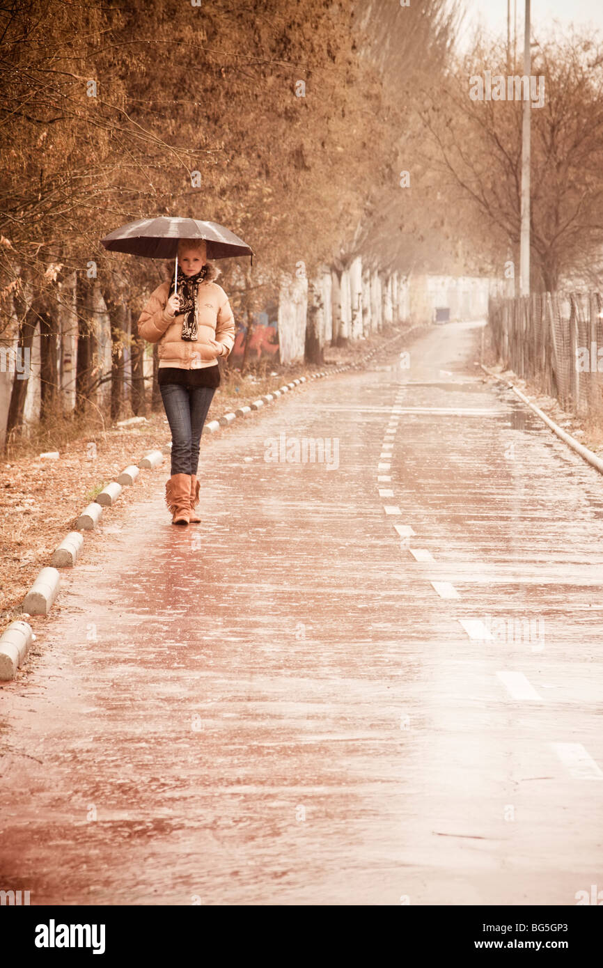 Woman umbrella rain trees hi-res stock photography and images - Alamy