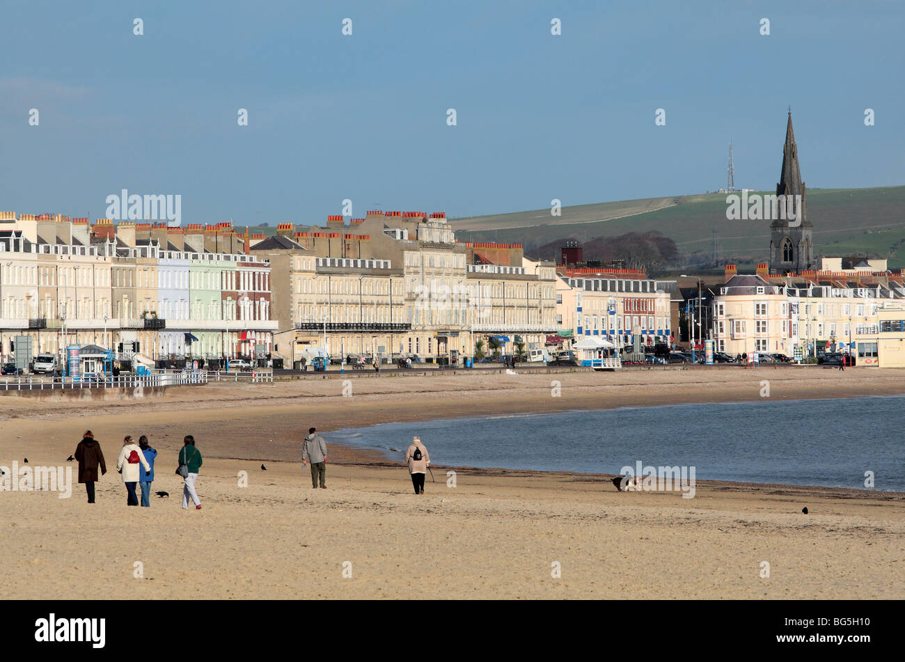 Weymouth beach in the golden glow of early evening in Winter with ...