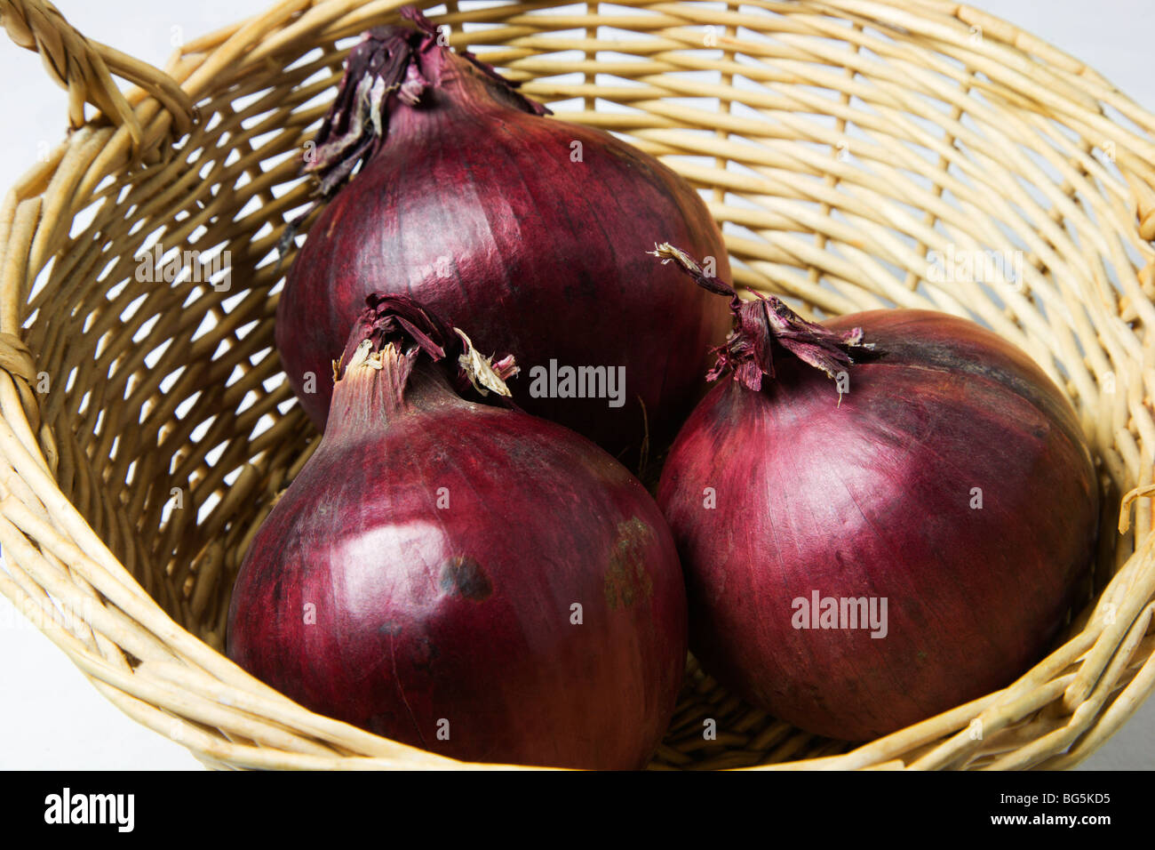 Three Red Onions in a Basket Stock Photo - Alamy