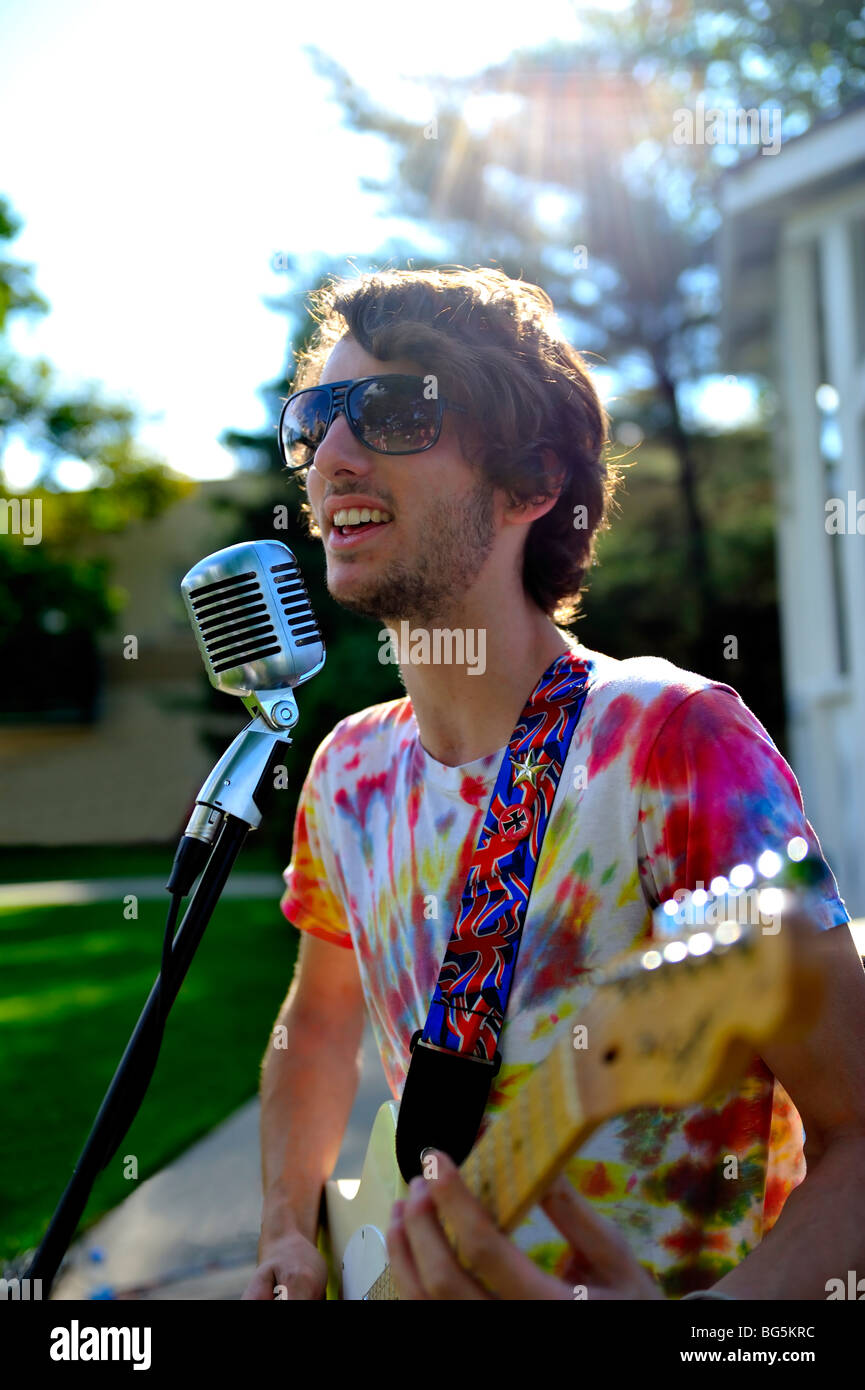 Guitar performance outside during the summer. Harsh lighting on hair ...