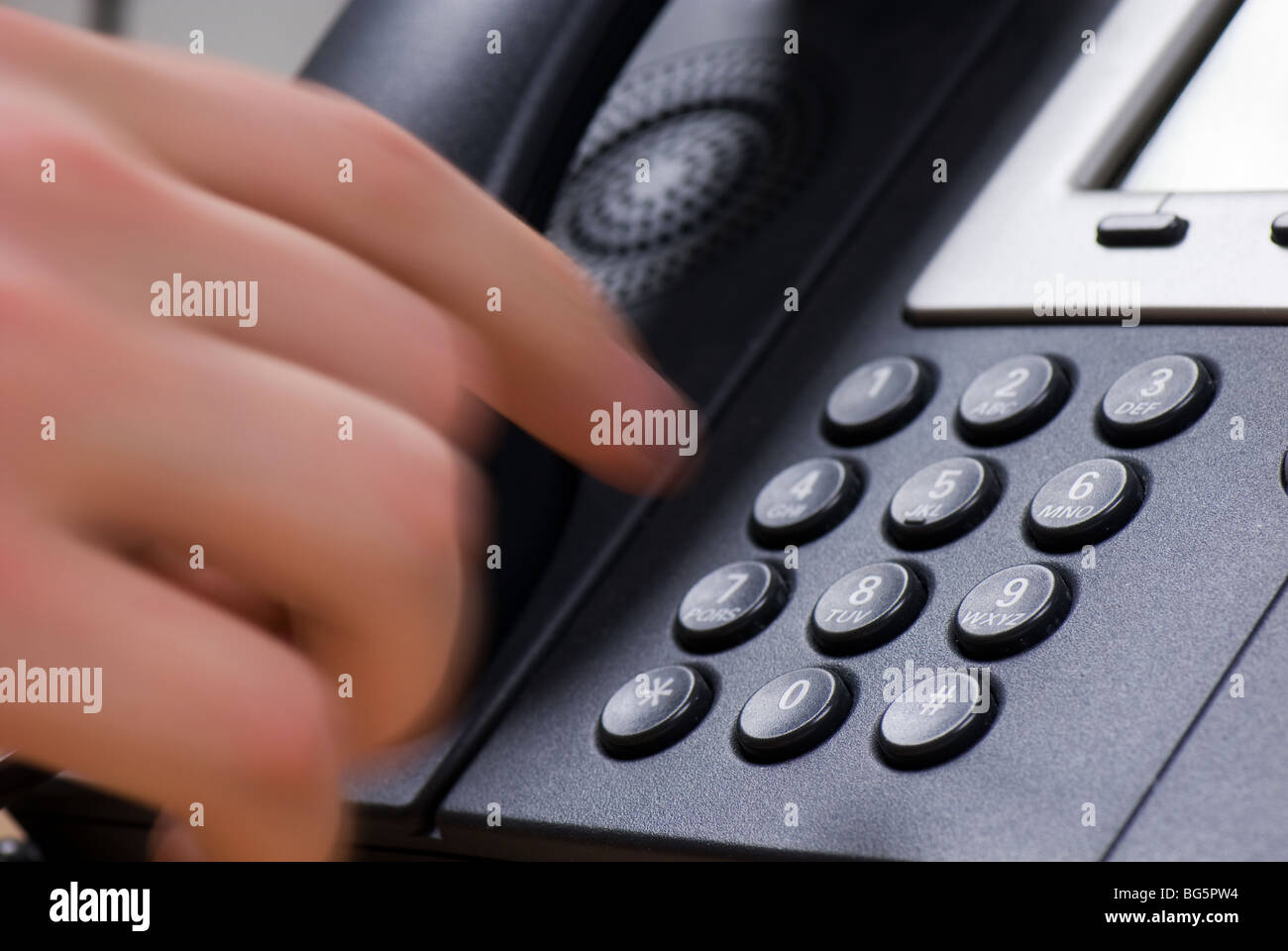 Hand dialing a phone number on a modern keypad Stock Photo - Alamy