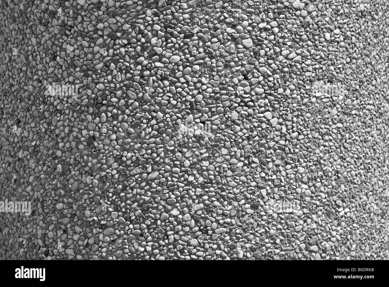 Textured pebble facade on a vertical column Stock Photo - Alamy