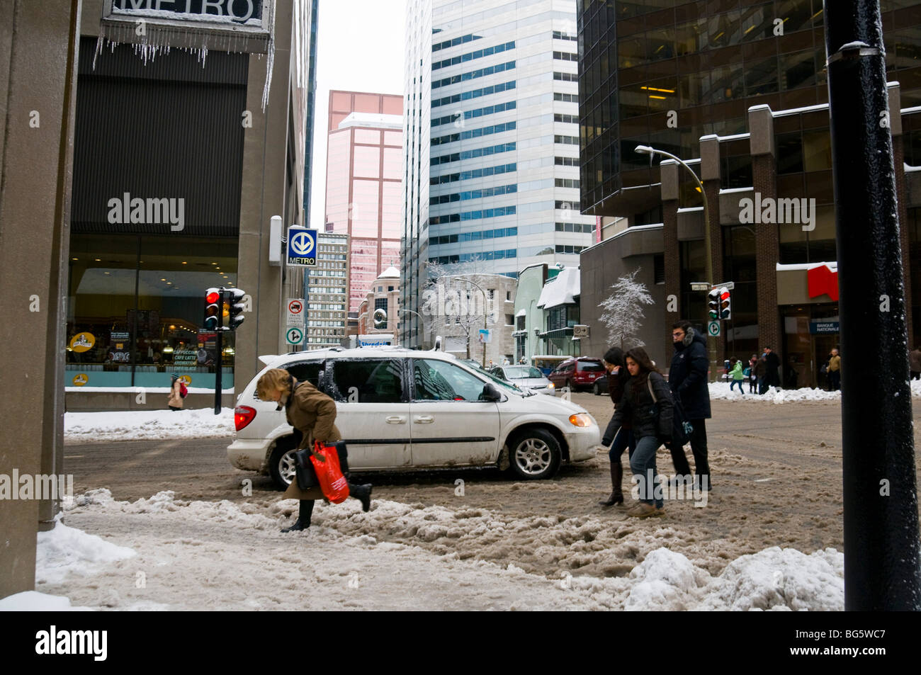 People battling with the mix of slush and snow in downtown Montreal ...