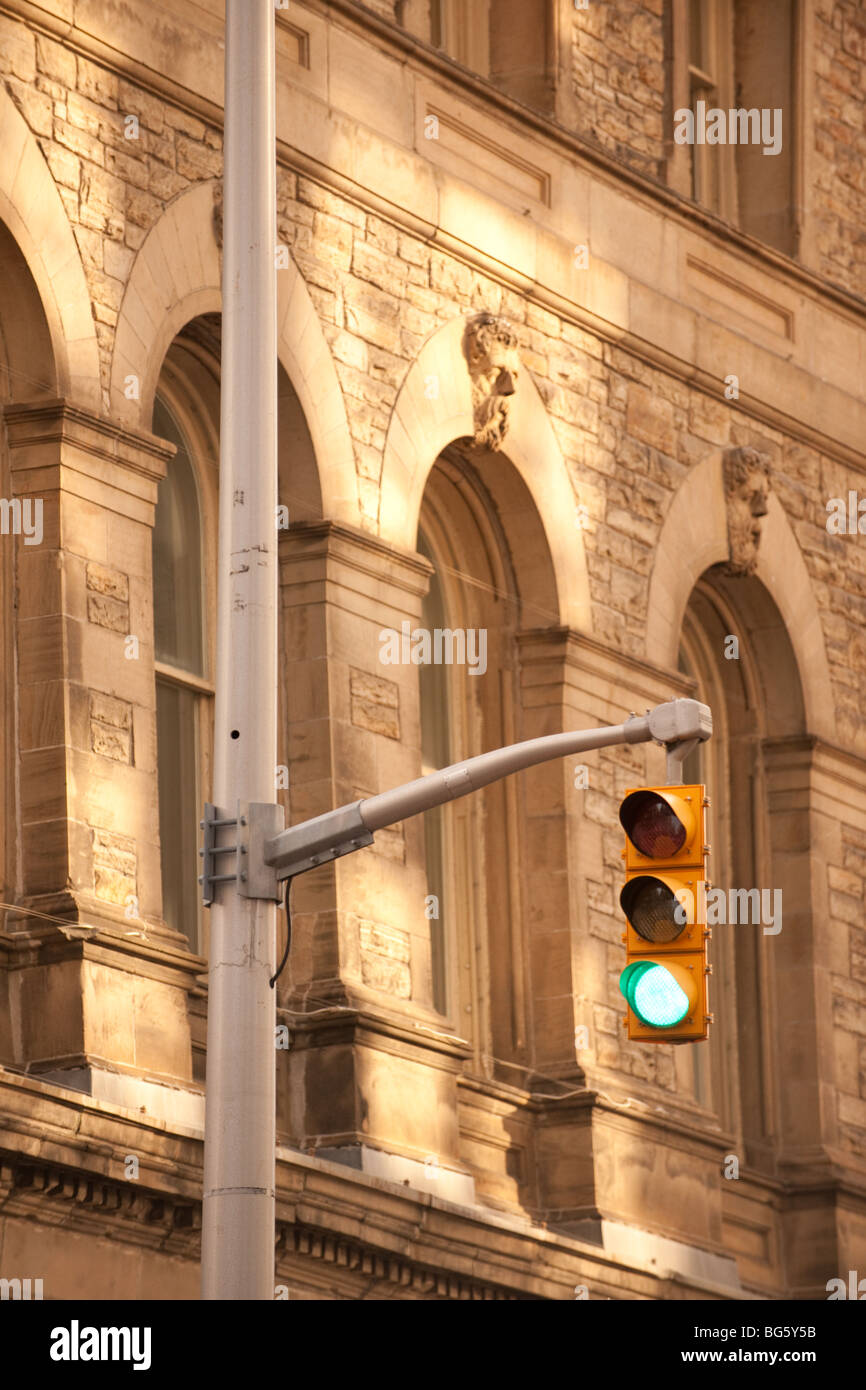 Traffic light signaling green in front of stone building Stock Photo ...