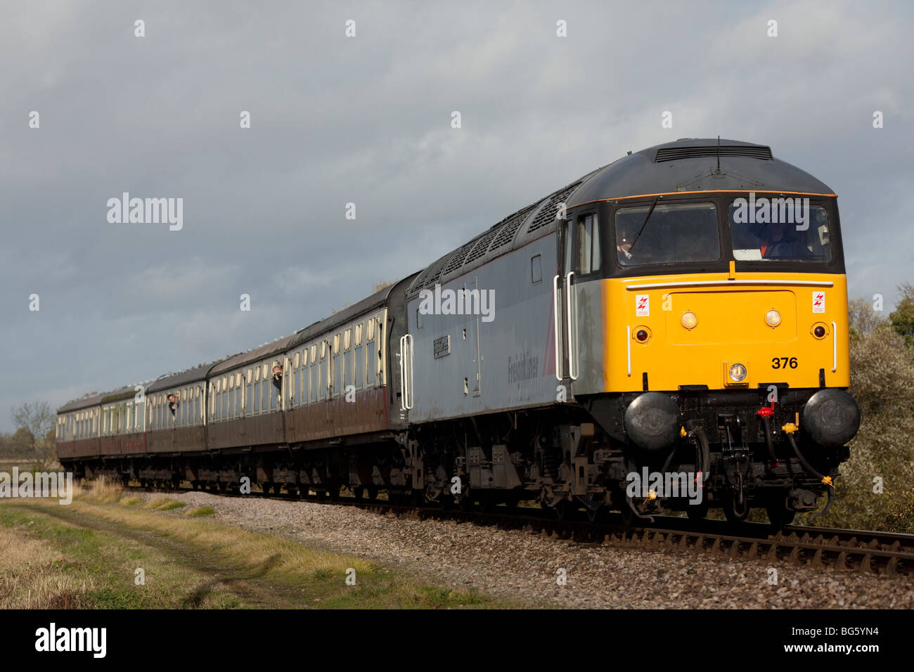 An old British diesel locomotive with carriages on a preserved railway ...