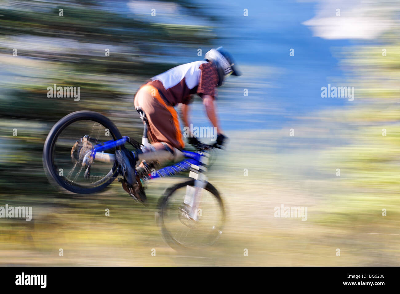 Rider performs a stoppy on mountain bike, Alberta, Canada Stock Photo ...