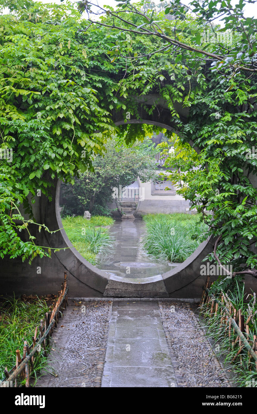 A traditional Chinese court yard round gate with vines Stock Photo - Alamy