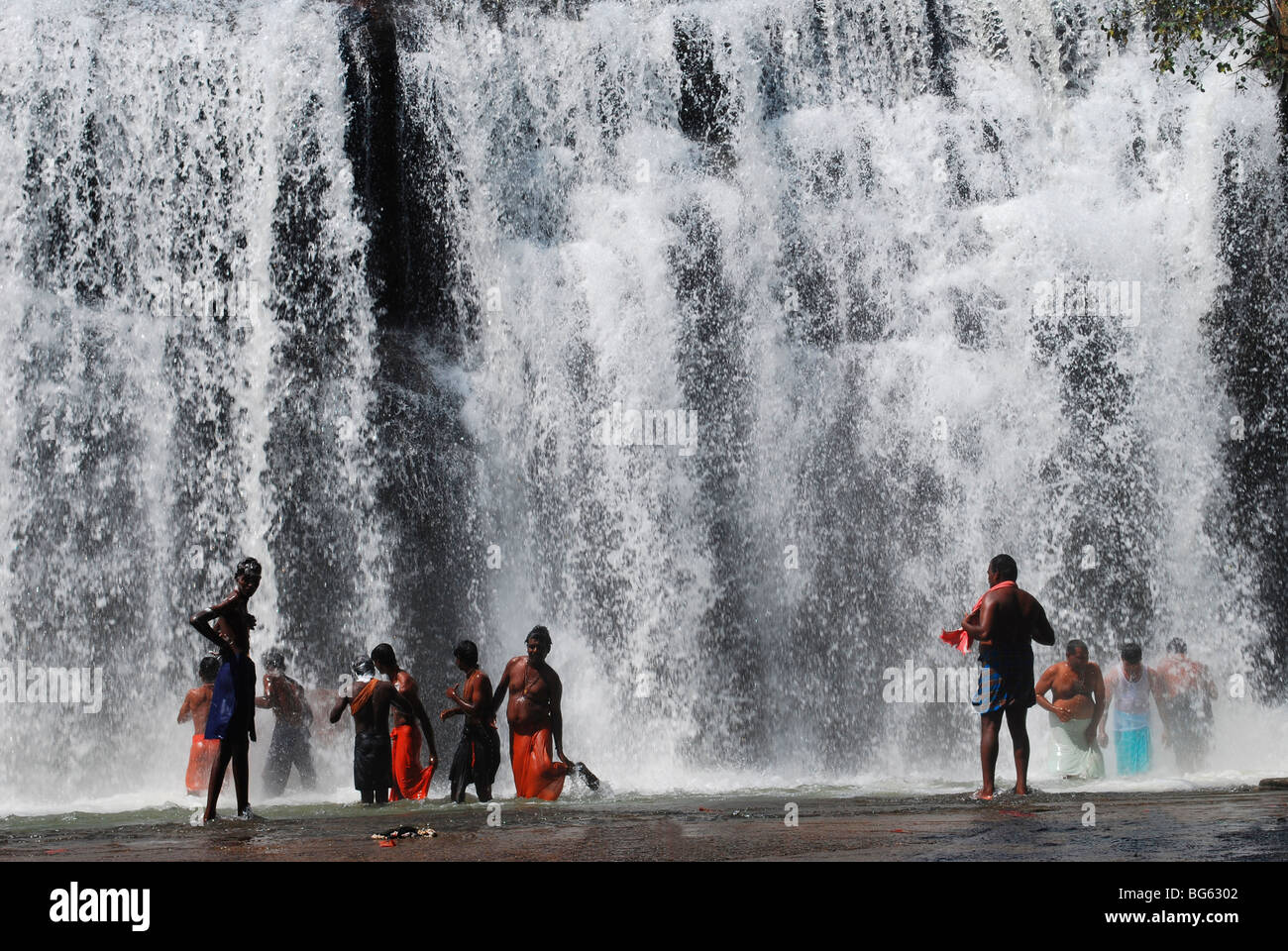 bathing in water fall ; india Stock Photo - Alamy