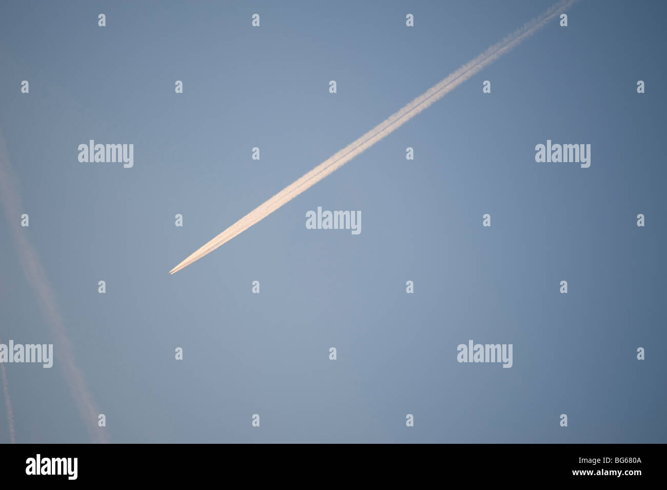 Vapour trails of a passing plane Stock Photo - Alamy