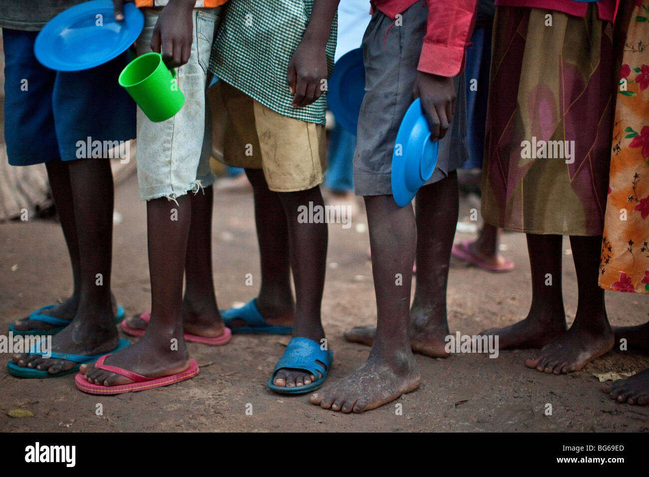 Children stand in a food distribution line in an orphanage in Amuria ...