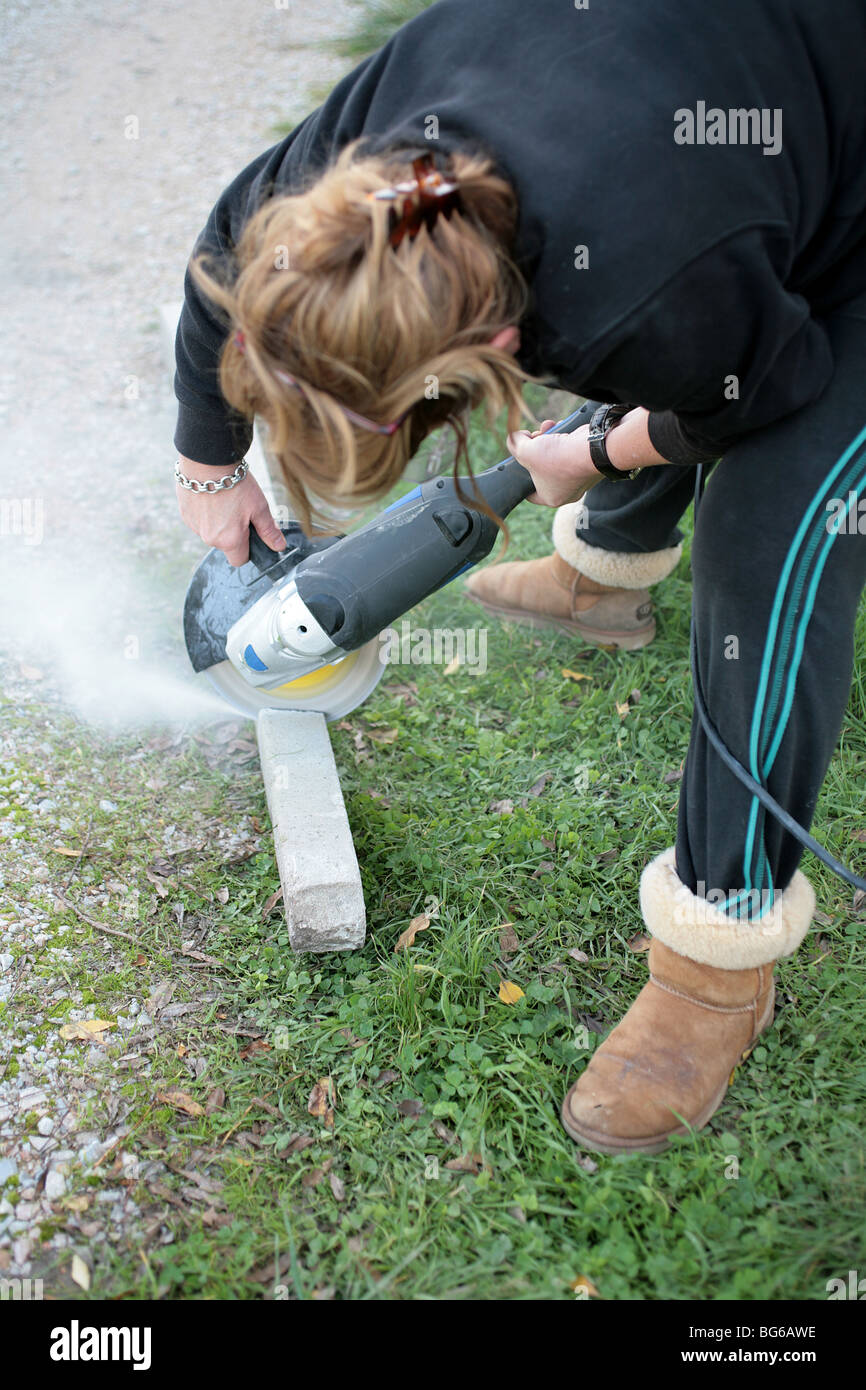 Woman using an angle grinder Stock Photo - Alamy