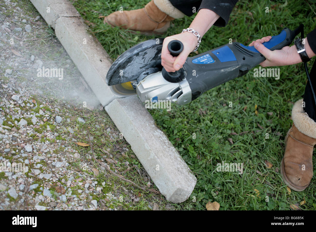 Woman using an angle grinder Stock Photo - Alamy