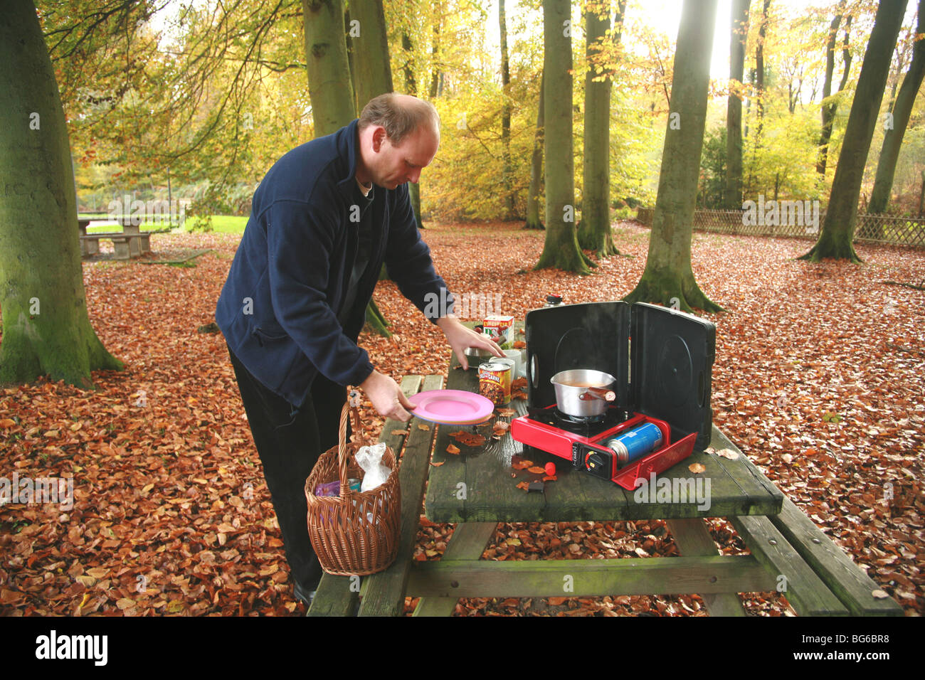Man cooking food in the woods Stock Photo - Alamy