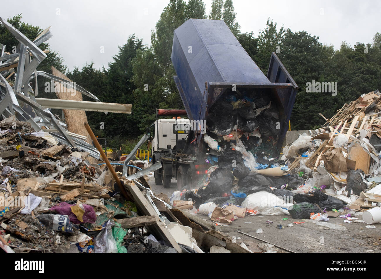 Lorry tipping rubbish at a materials recycling facility in England ...