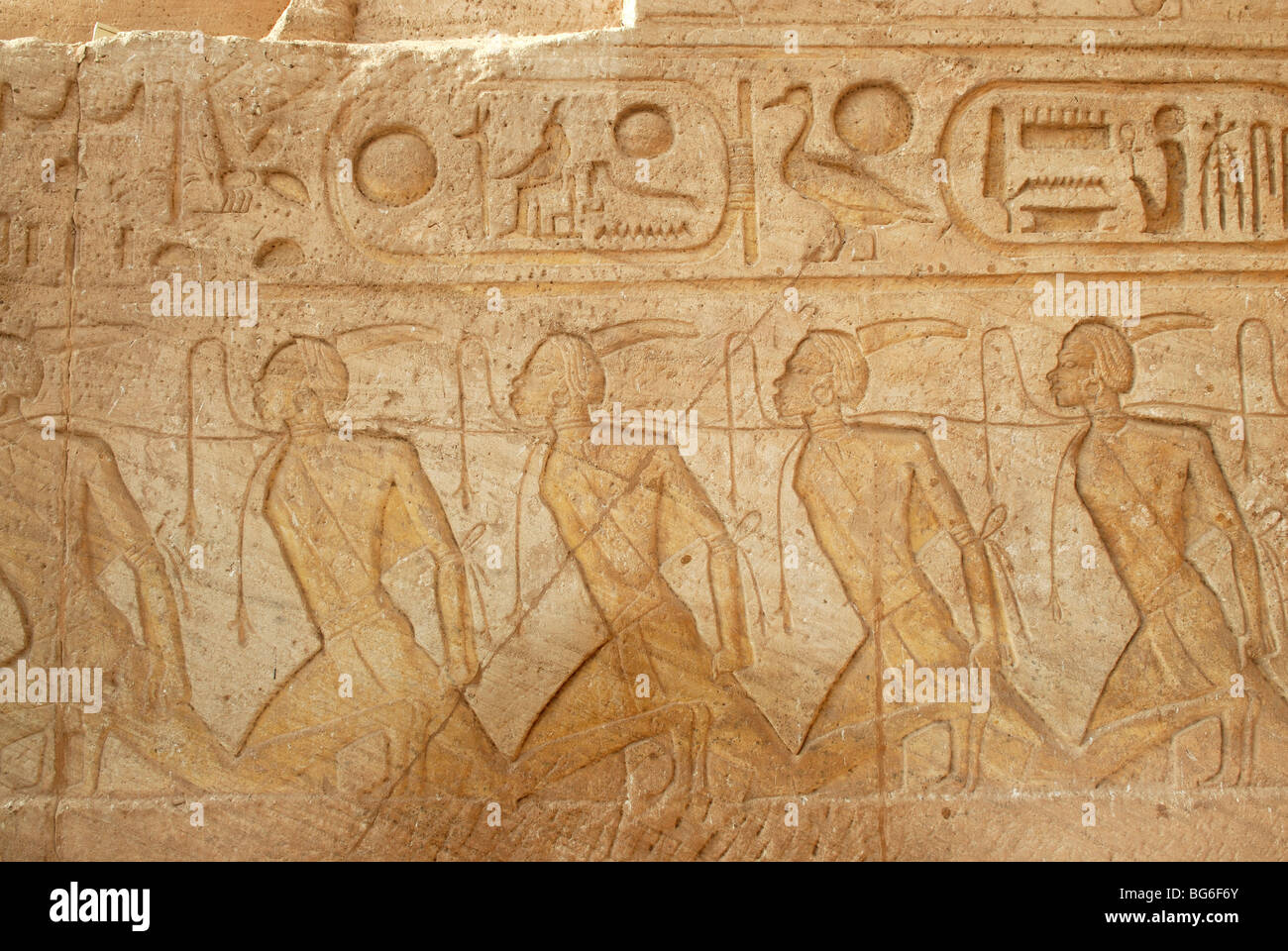 Reliefs on the base of Ramses II statues of Abu Simbel temple in Egypt ...