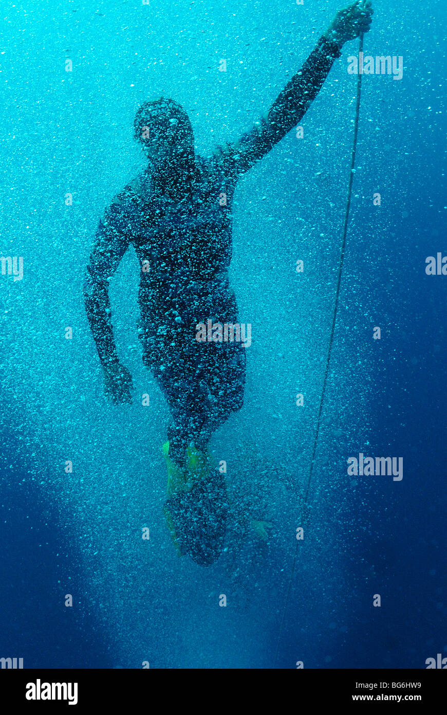Free diver going up along a rope in the Mediterranean Sea, off Monaco ...