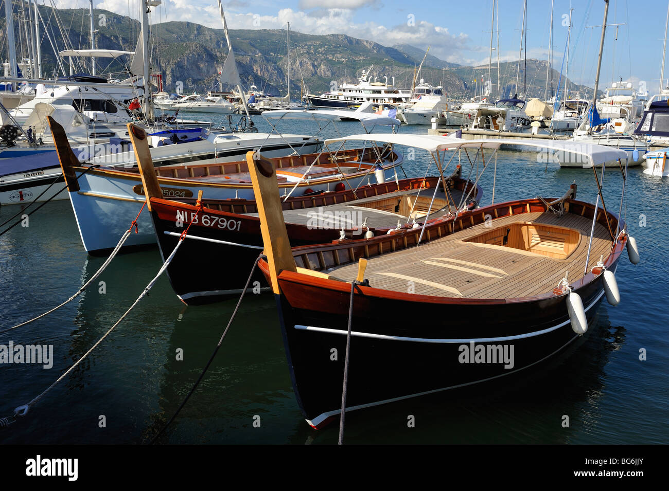 Small wood fishing boats moored in Saint Jean Cap Ferrat harbour ...