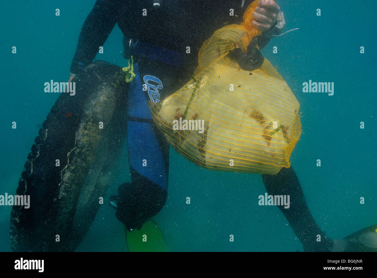 Scuba diver removing waste from the underwater bottoms of Saint Jean ...