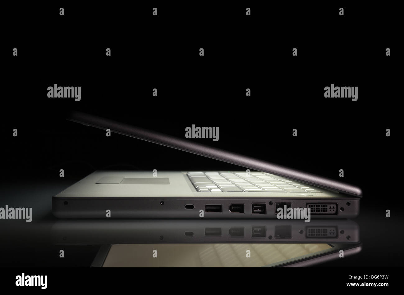 Silver laptop laptop with a luminous screen on a reflection surface, on ...