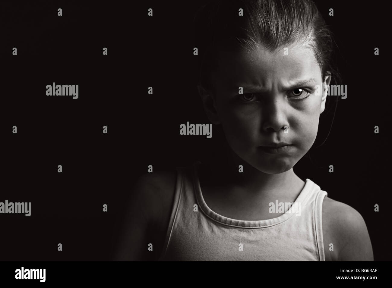 Powerful Low Key Shot of a Child with Attitude Stock Photo - Alamy