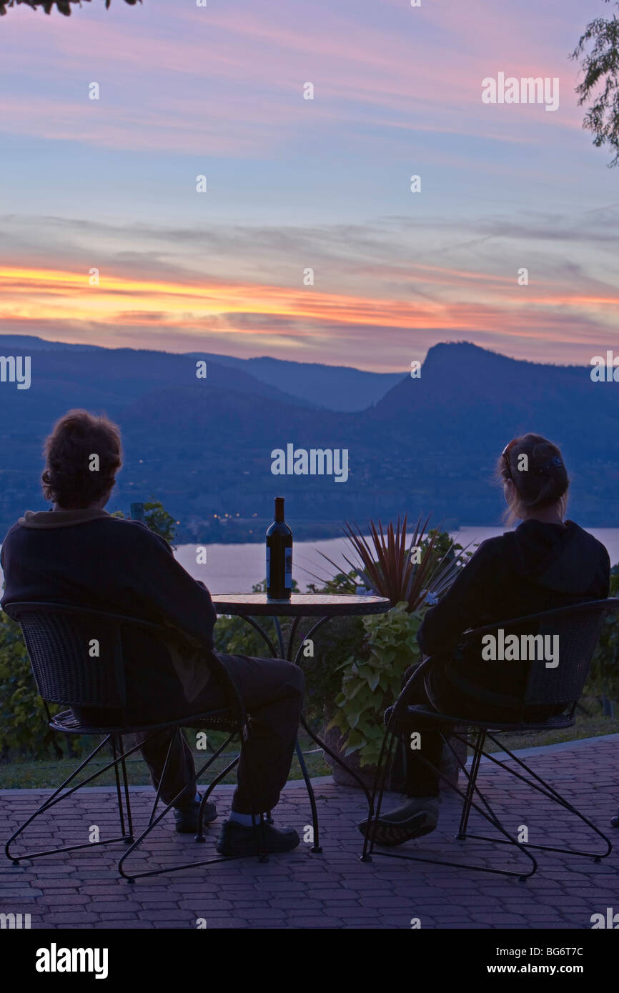 Couple sitting at a patio table overlooking the grapevines of Lang ...