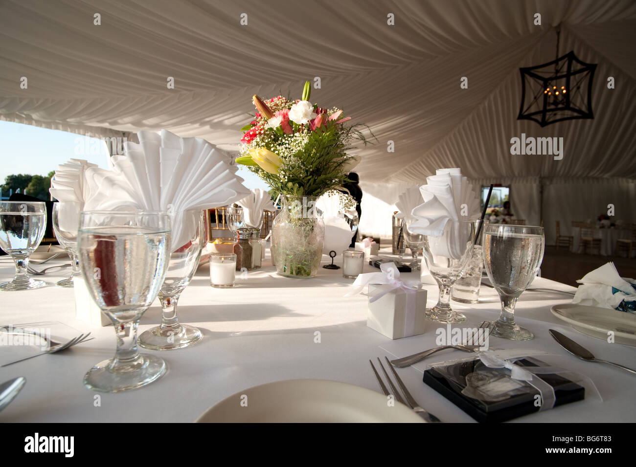 Wedding reception table with flowers and gifts for guests Stock Photo ...