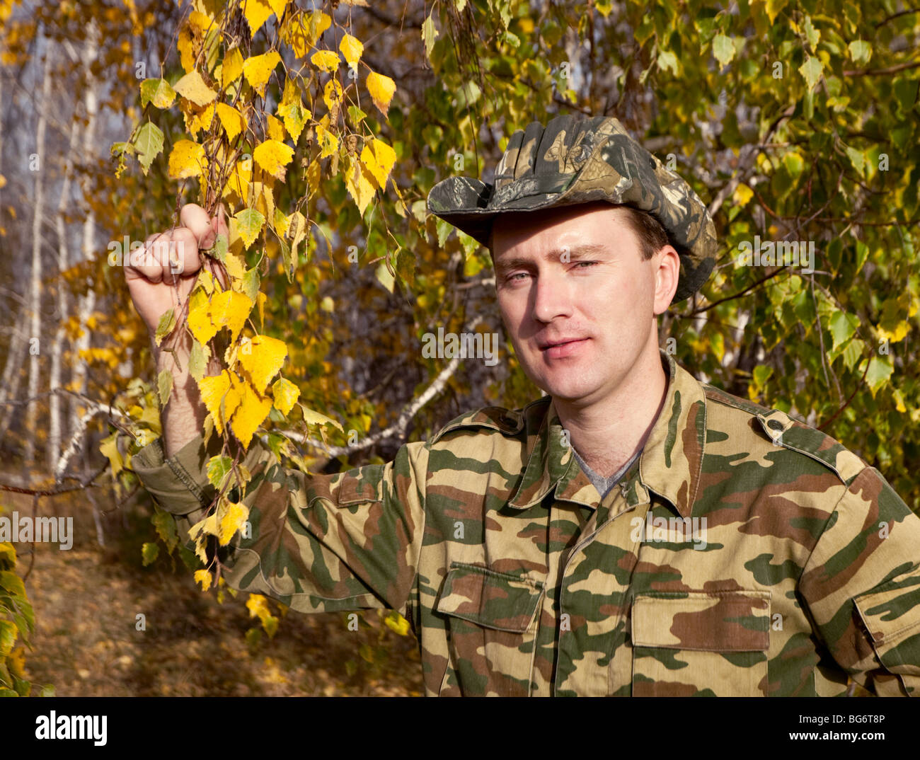 Man in military uniform in autumn forest Stock Photo - Alamy