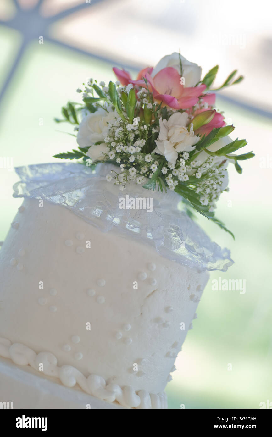 Wedding cake with decorative flowers on top Stock Photo - Alamy