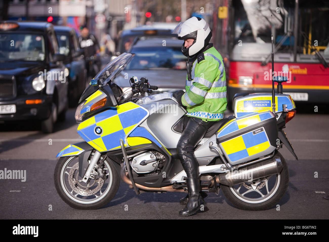 Police holding up traffic at a junction in London Stock Photo - Alamy