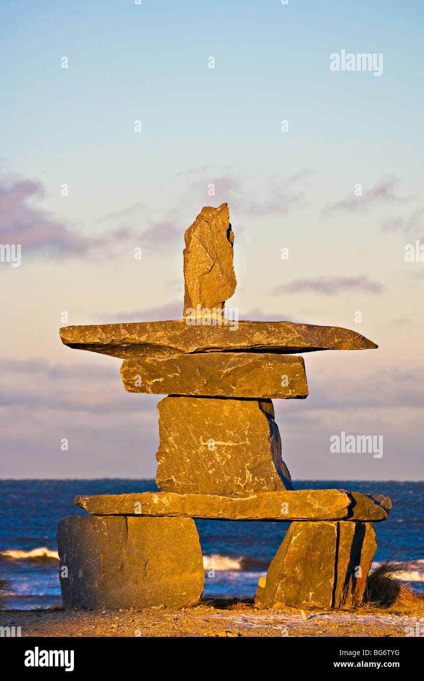 Inukshuk at sunset in the town of Churchill on the shores of Hudson Bay ...