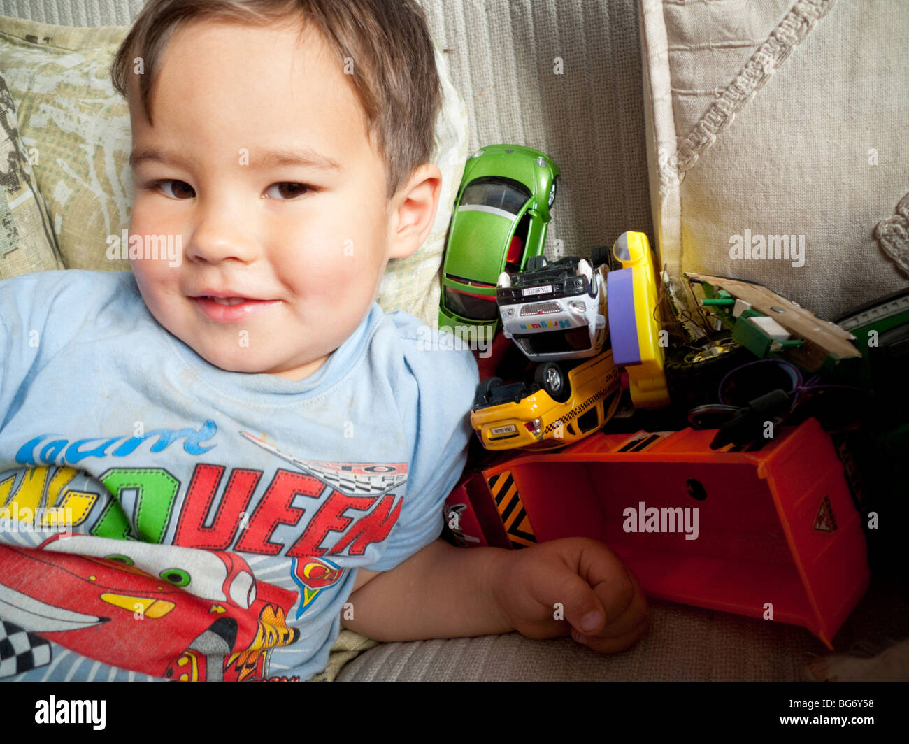 Little boy playing with toys Stock Photo - Alamy
