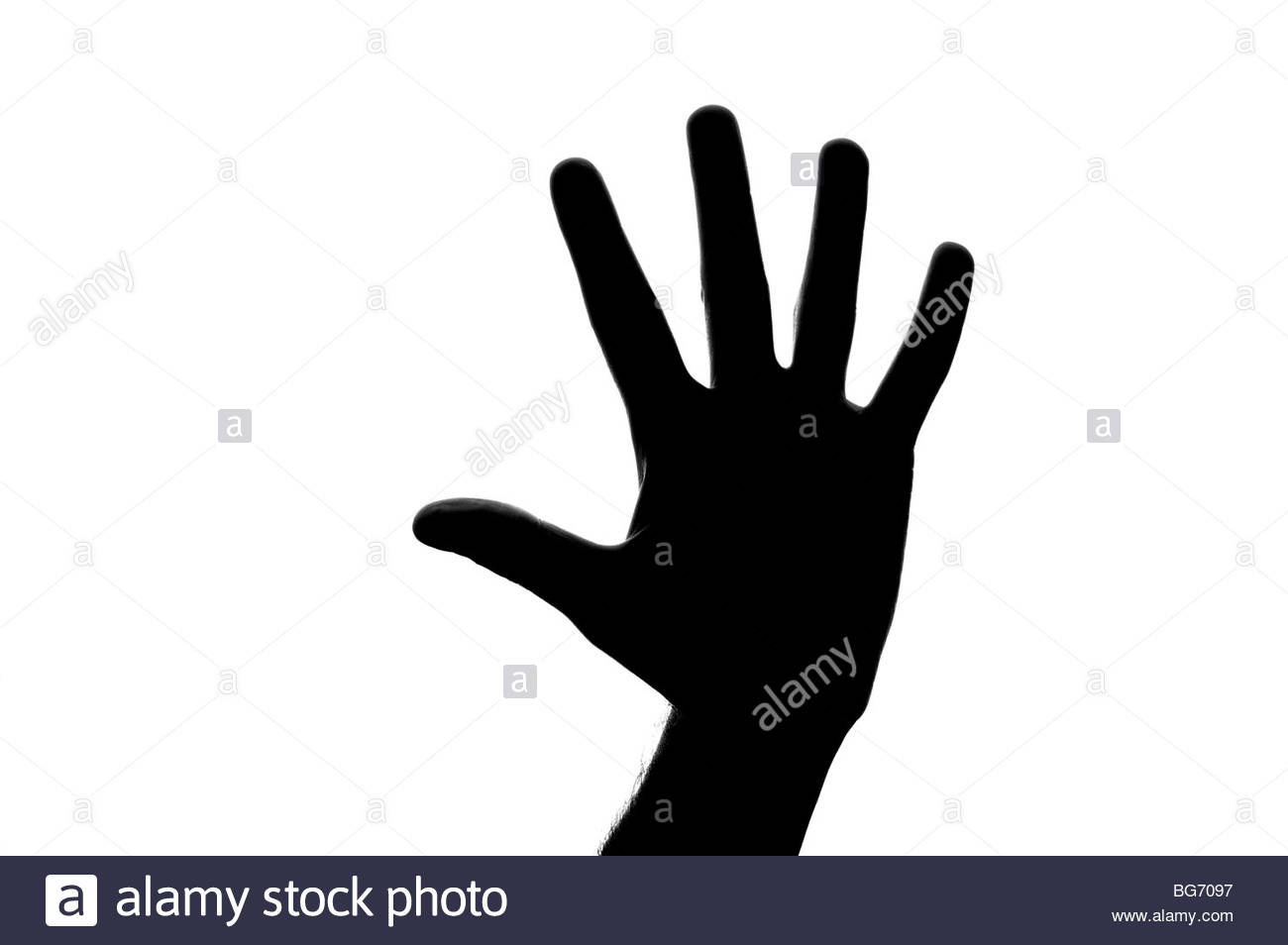 Silhouetted mans left hand Stock Photo - Alamy