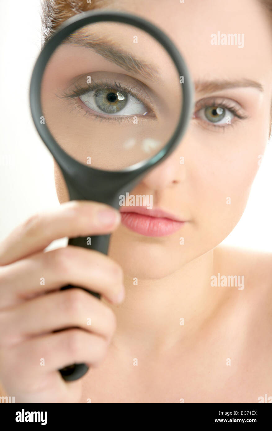 Portrait of woman with magnifier lens on eye isolated on white Stock ...