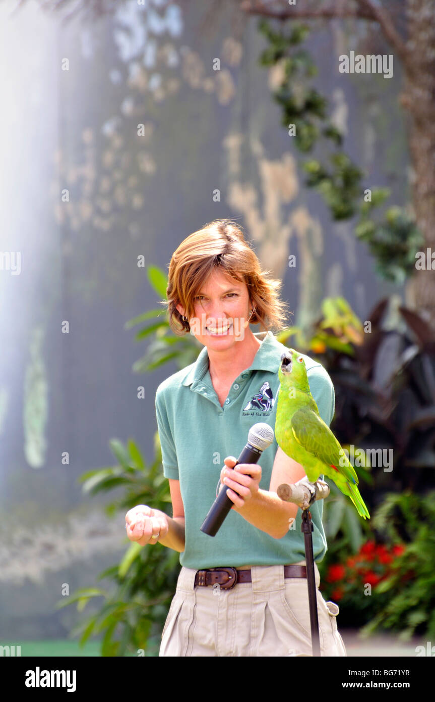 Girl with talking parrot Stock Photo - Alamy