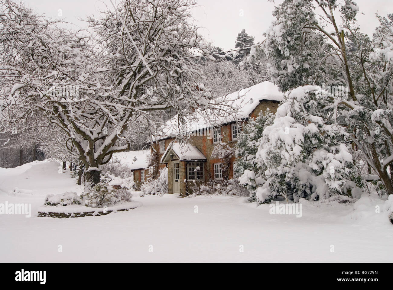 Christmas card image of a snowy landscape scene with a cozy cottage ...
