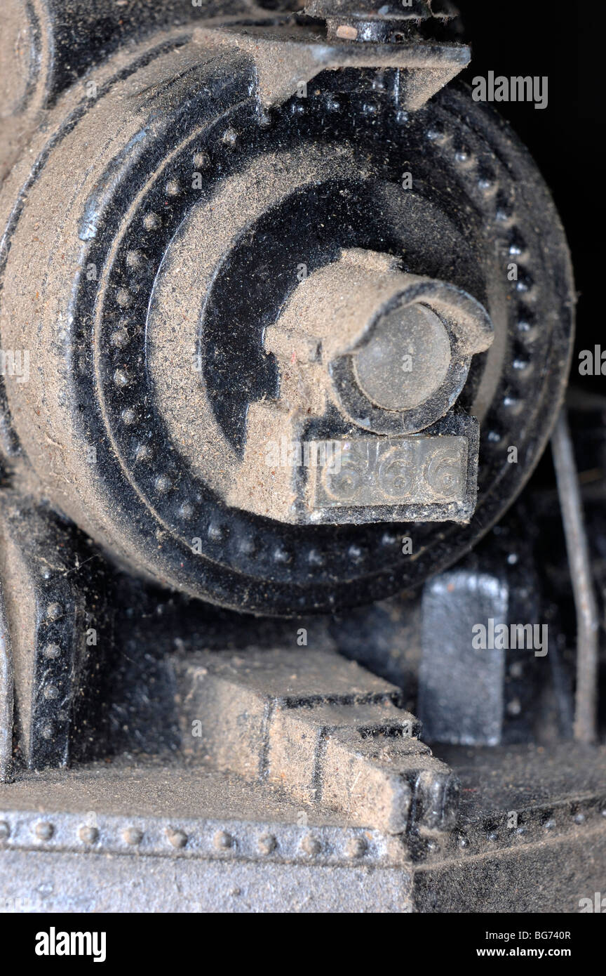 Closeup of the front of an old dust covered electric toy railroad steam ...