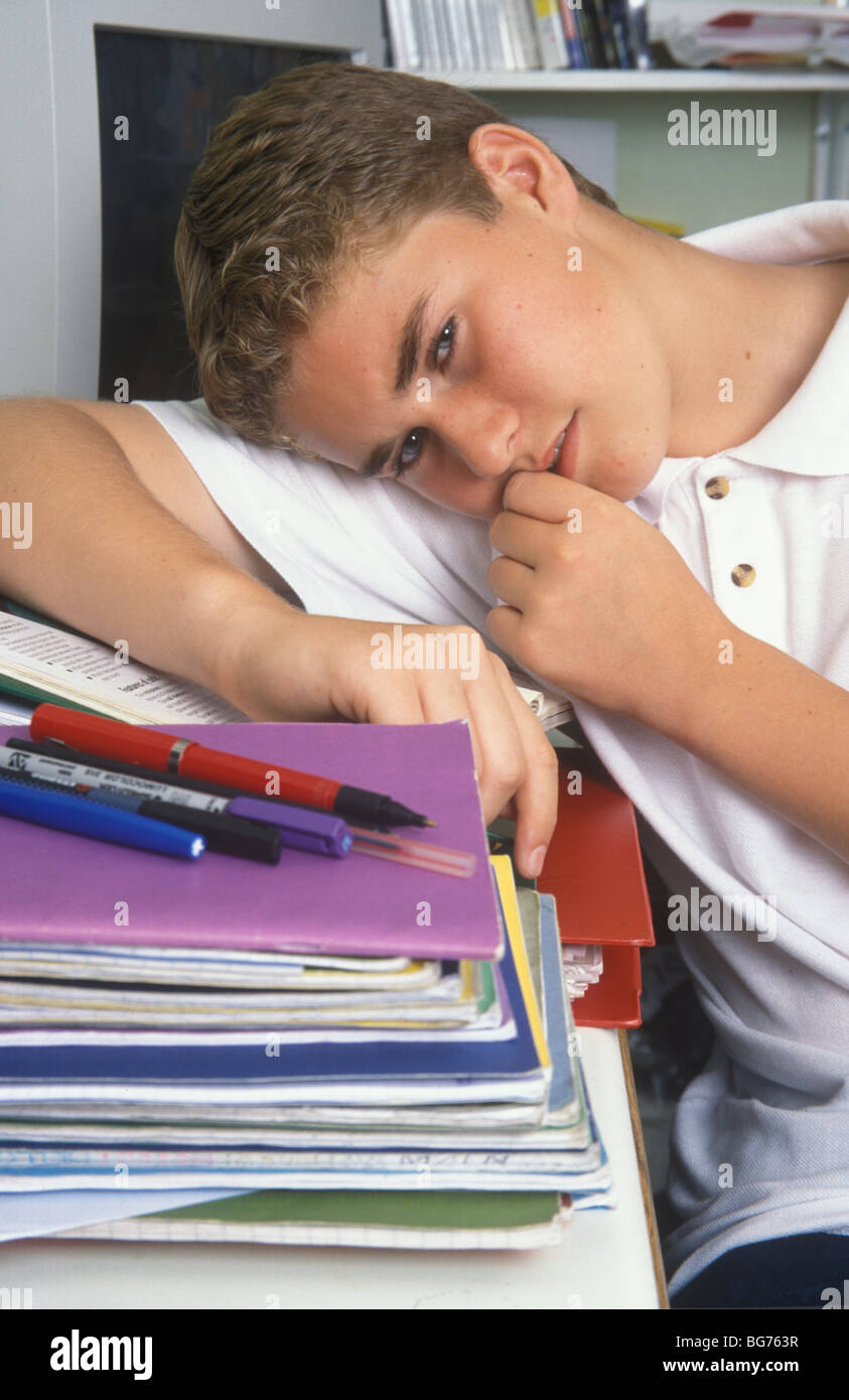 teenage boy looking tired as he trys to study Stock Photo - Alamy