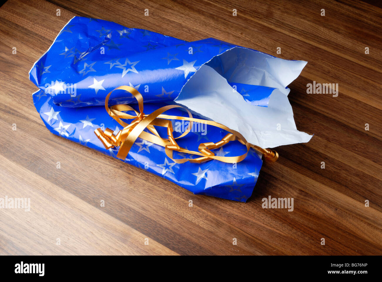 Torn gift wrapping on floor Stock Photo - Alamy