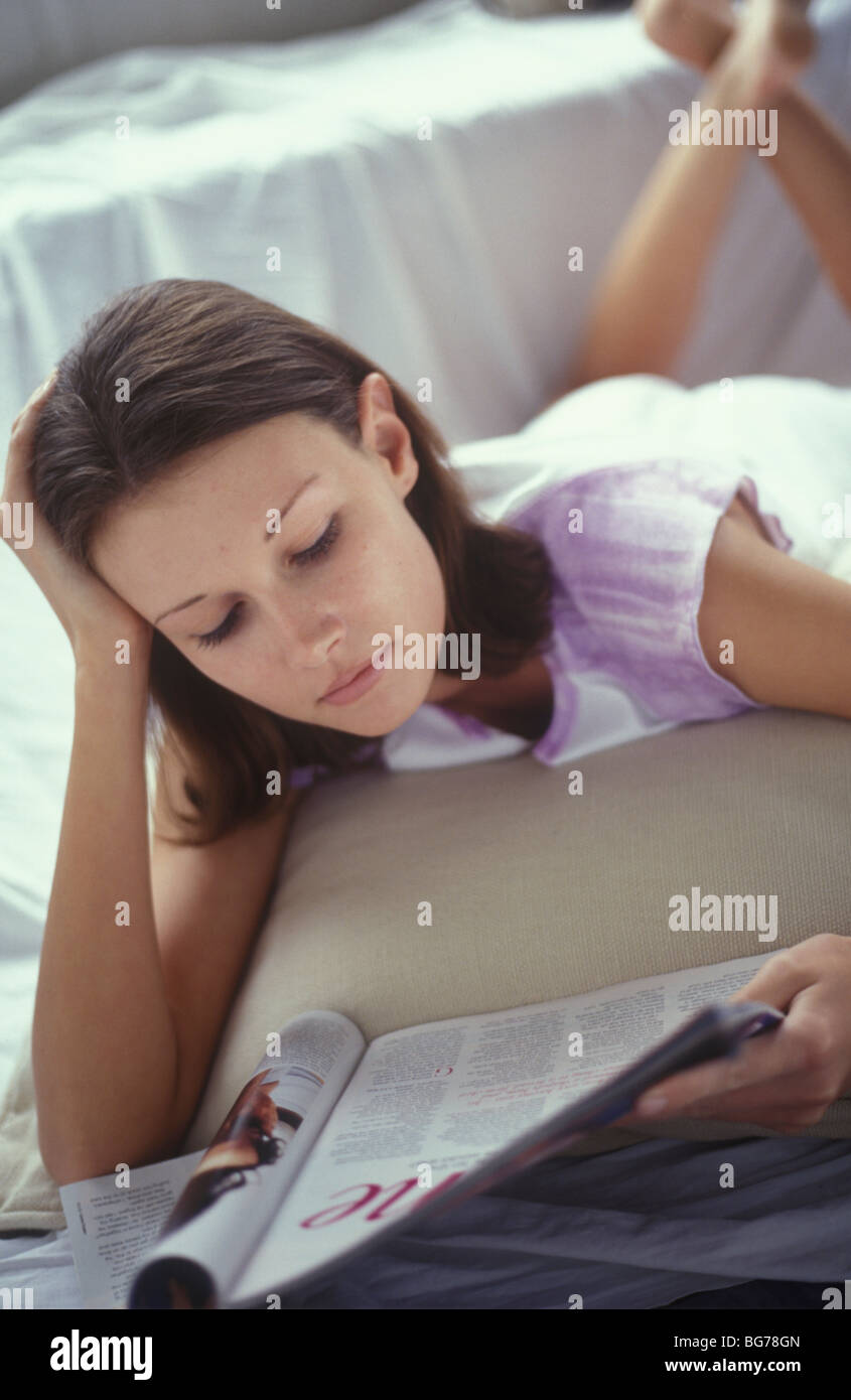 Girl relaxing reading a magazine Stock Photo - Alamy