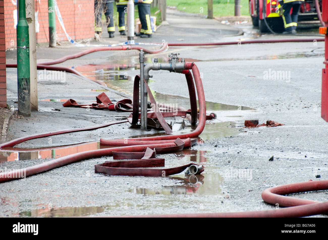 Fire hose in hydrant with twin branch and fallen masonry Stock Photo ...