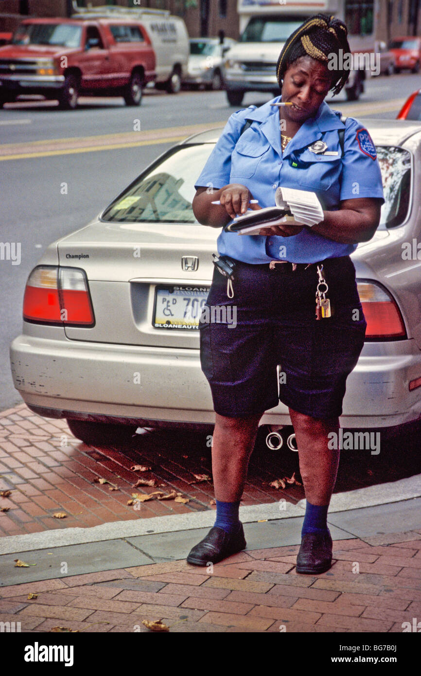 One African American traffic cop writes parking violation ticket Stock ...