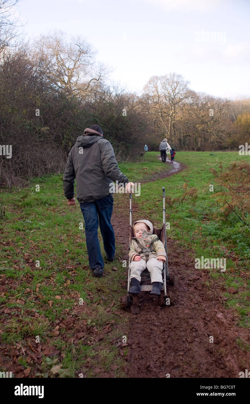 Dragging a young child in buggy through the mud at Occombe farm 2km ...
