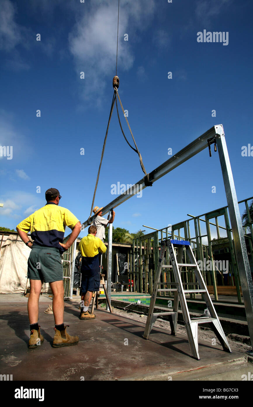 A construction worker places a steel girder during the building of a ...