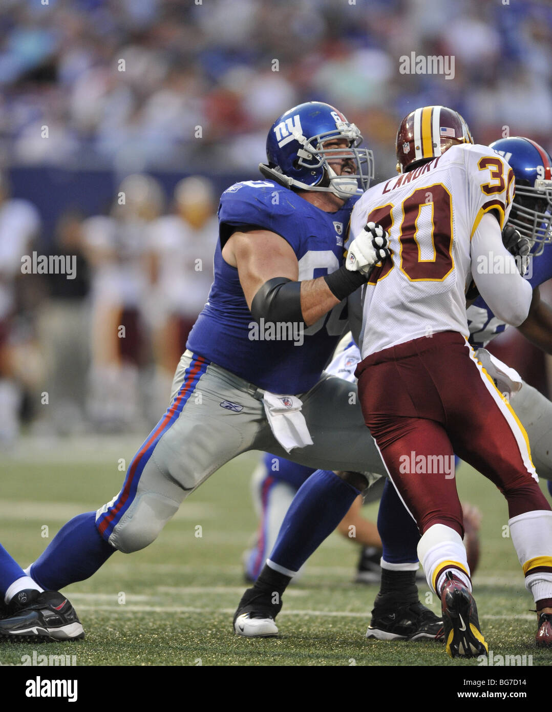 An offensive lineman blocks the approaching defensive player Stock ...