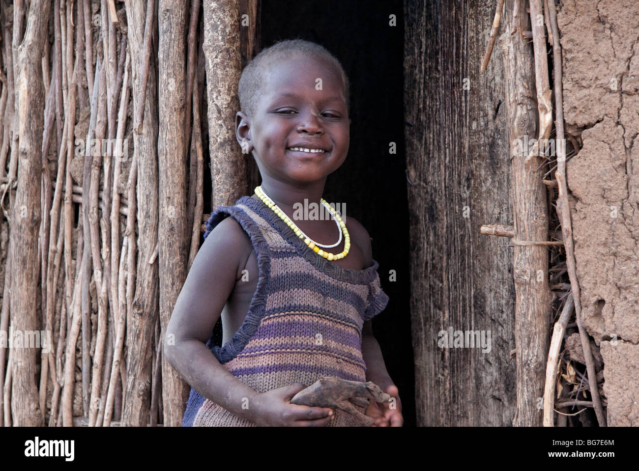 African boy smiling at his houses door Stock Photo - Alamy